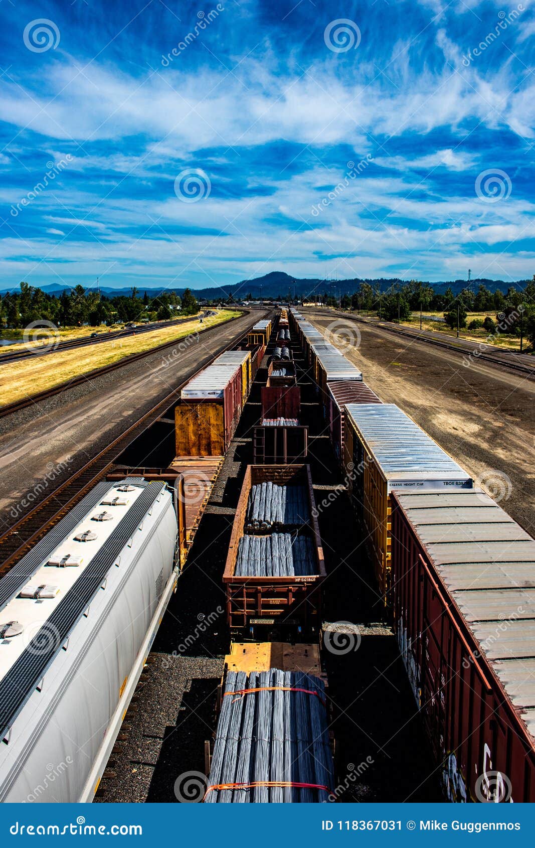 Train Cars Vertical Down a Track Overlooking Mountain Range. Stock ...
