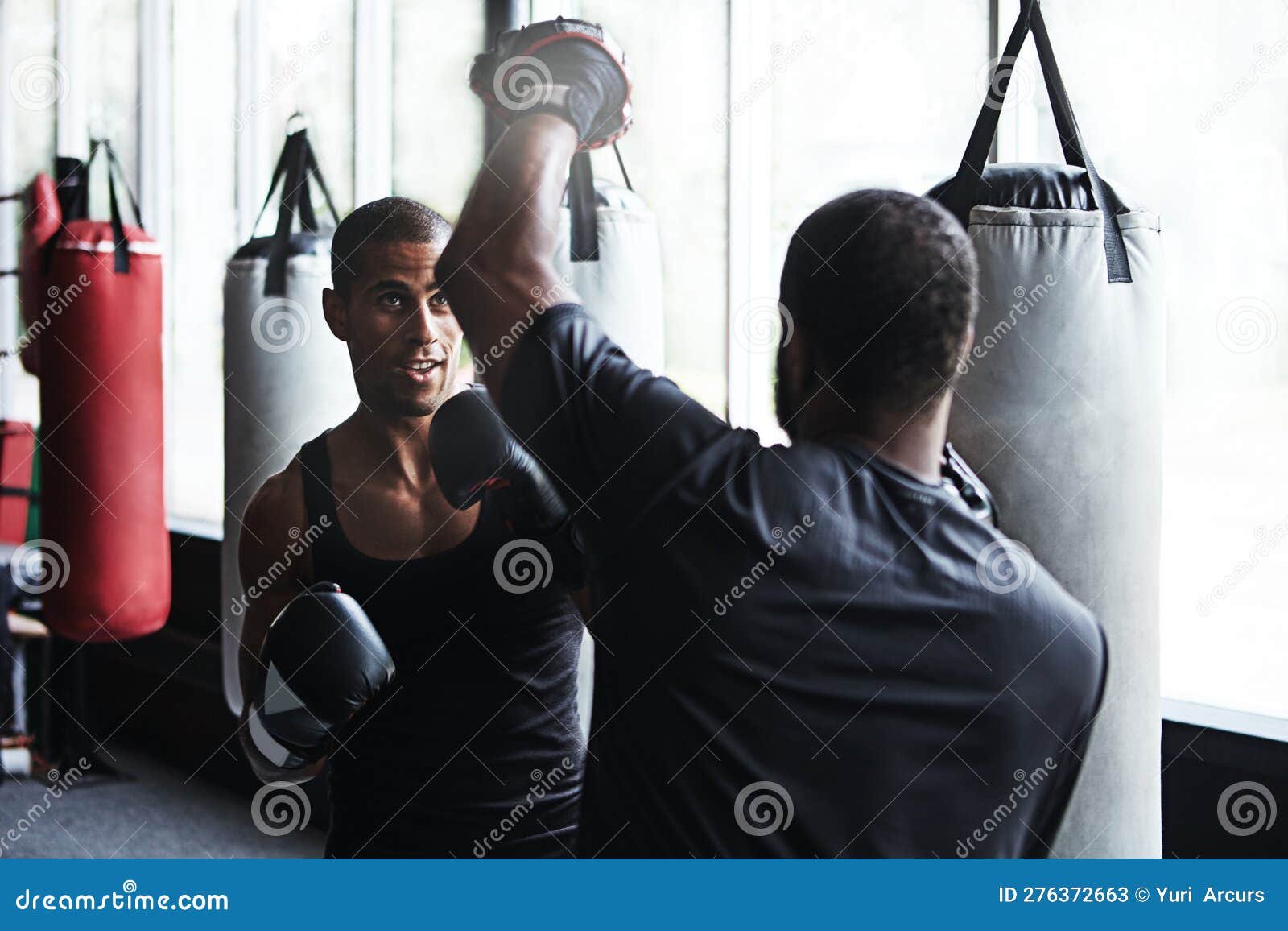 Train Hard and it Will Pay Off. a Male Boxer Practising His Moves with ...