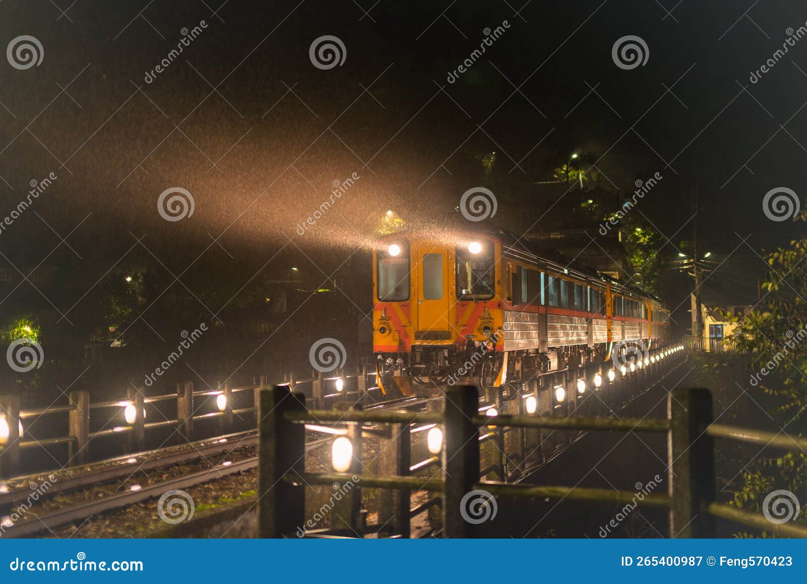 The Train with Lights on Was Running on the Bridge in the Rain ...