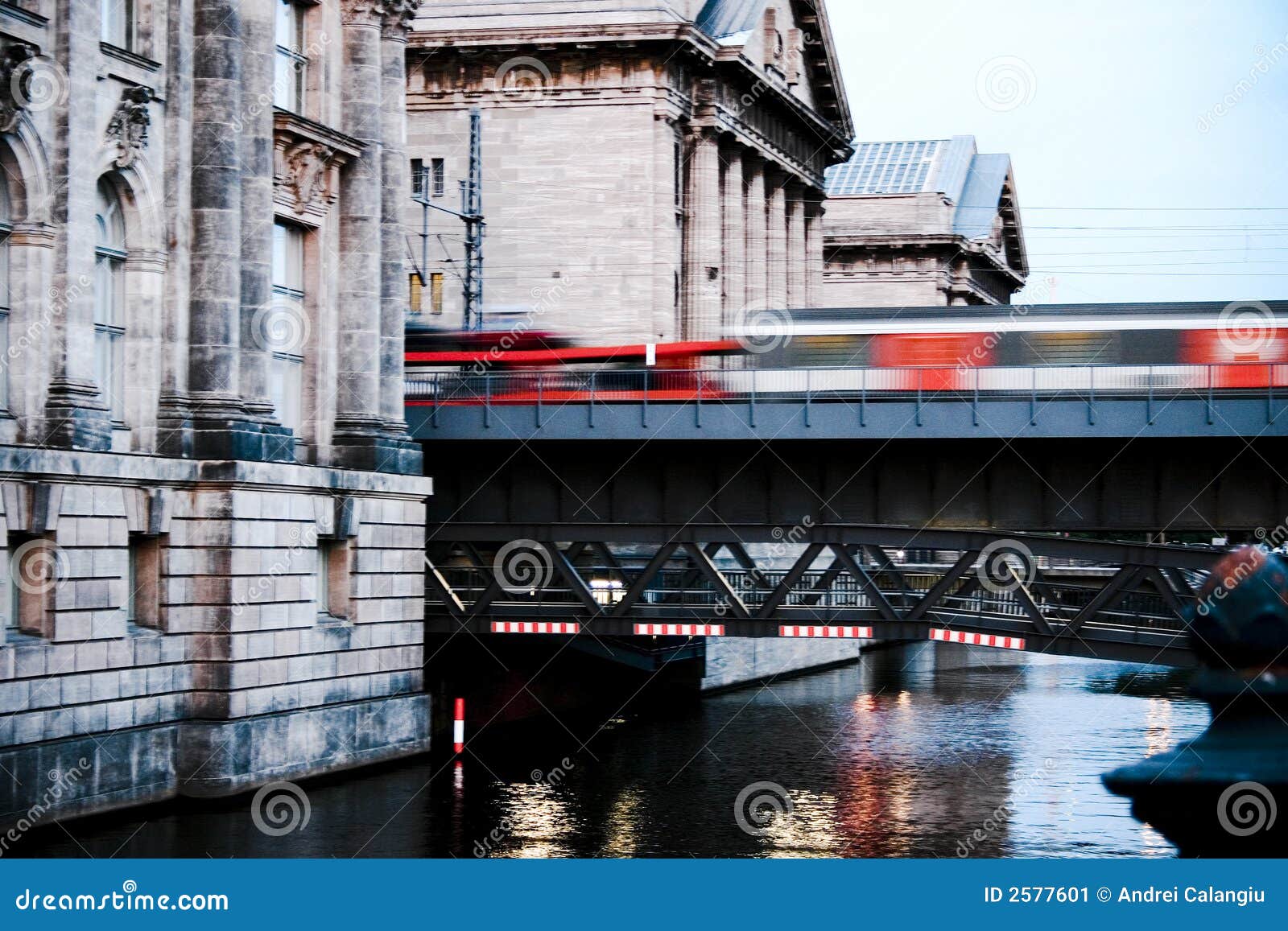 Train moving across bridge stock image. Image of buildings - 2577601