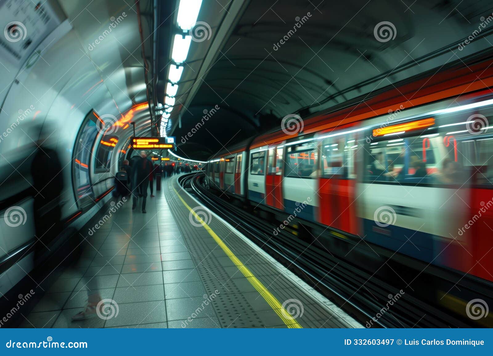 A Train is Moving through a Subway Station with People Walking on the ...