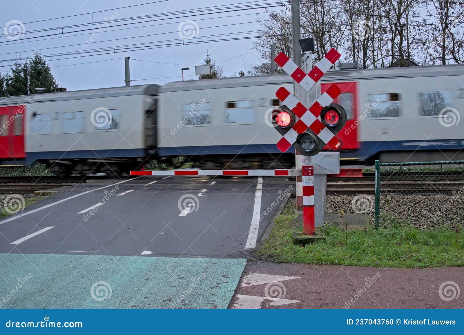 Train Passing a Level Crossing with Red Light Stock Photo - Image of ...