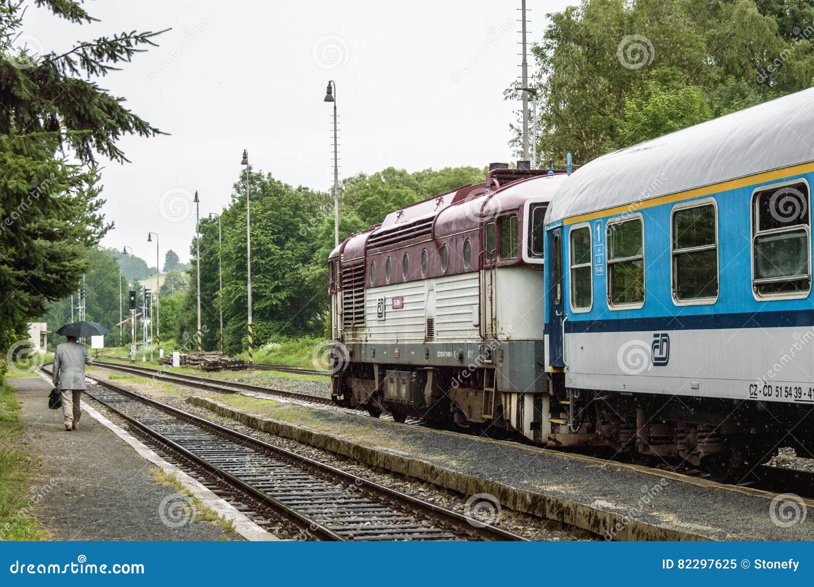 Train Passing Parallel To a Man Walking on a Platform Editorial Image ...