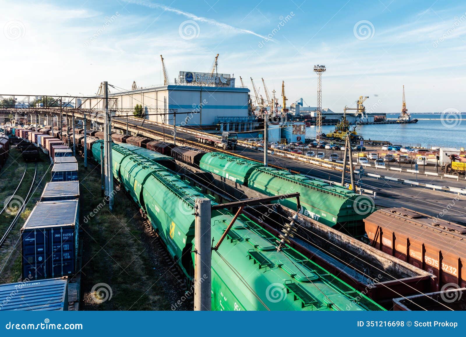 A Train is Pulling into a Station with a Large Building in the ...