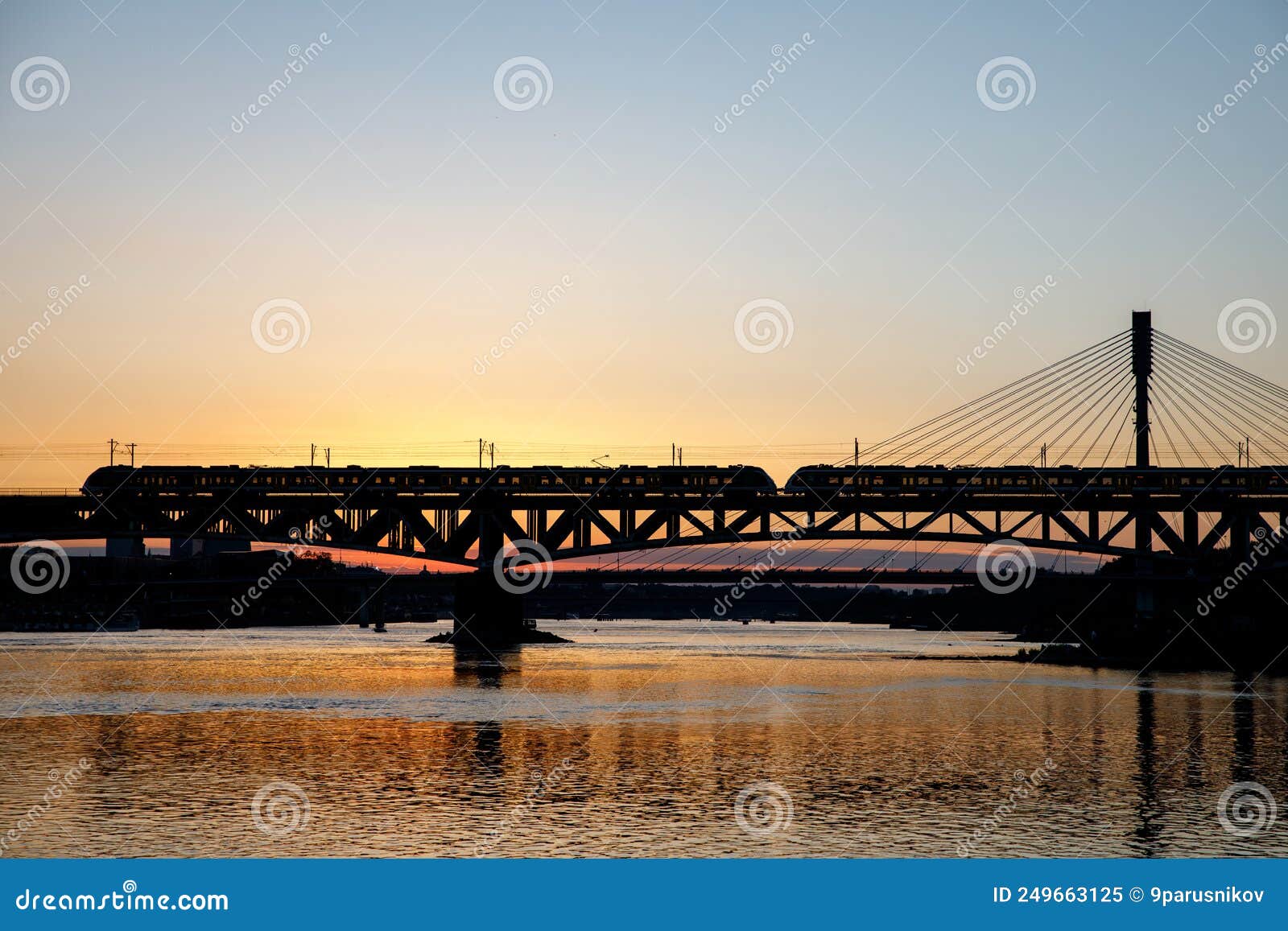 The Train Riding Over the Bridge Over the River at Sunset. Editorial ...