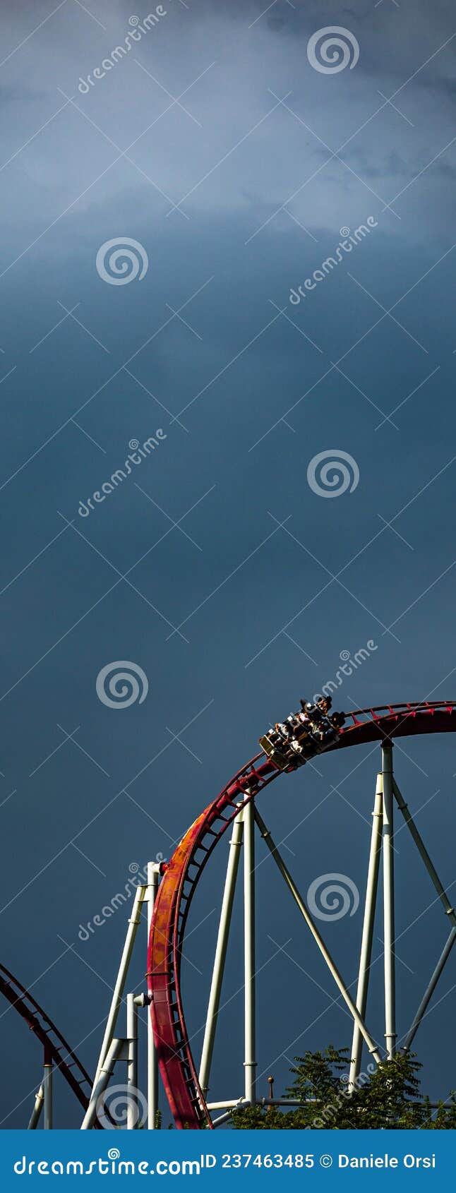 The Train with Some People is Riding on Roller Coaster during a Cloudy ...