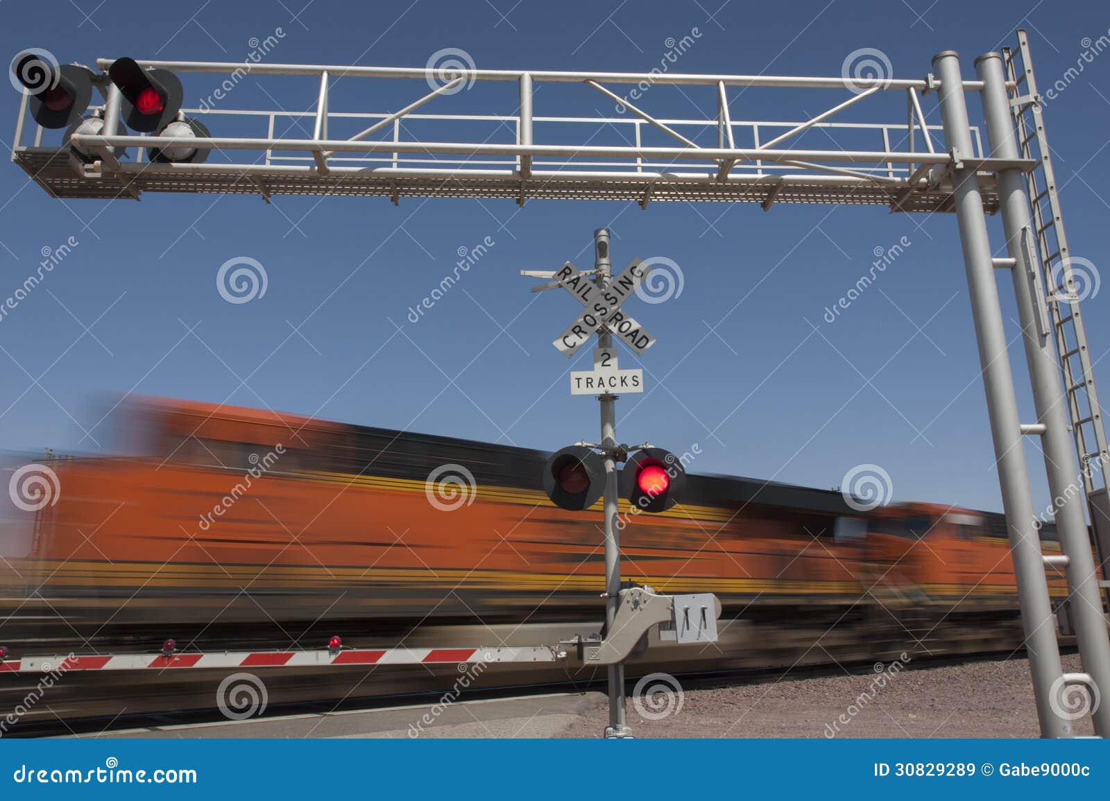 Train Speeding by Railroad Crossing Stock Image - Image of train ...