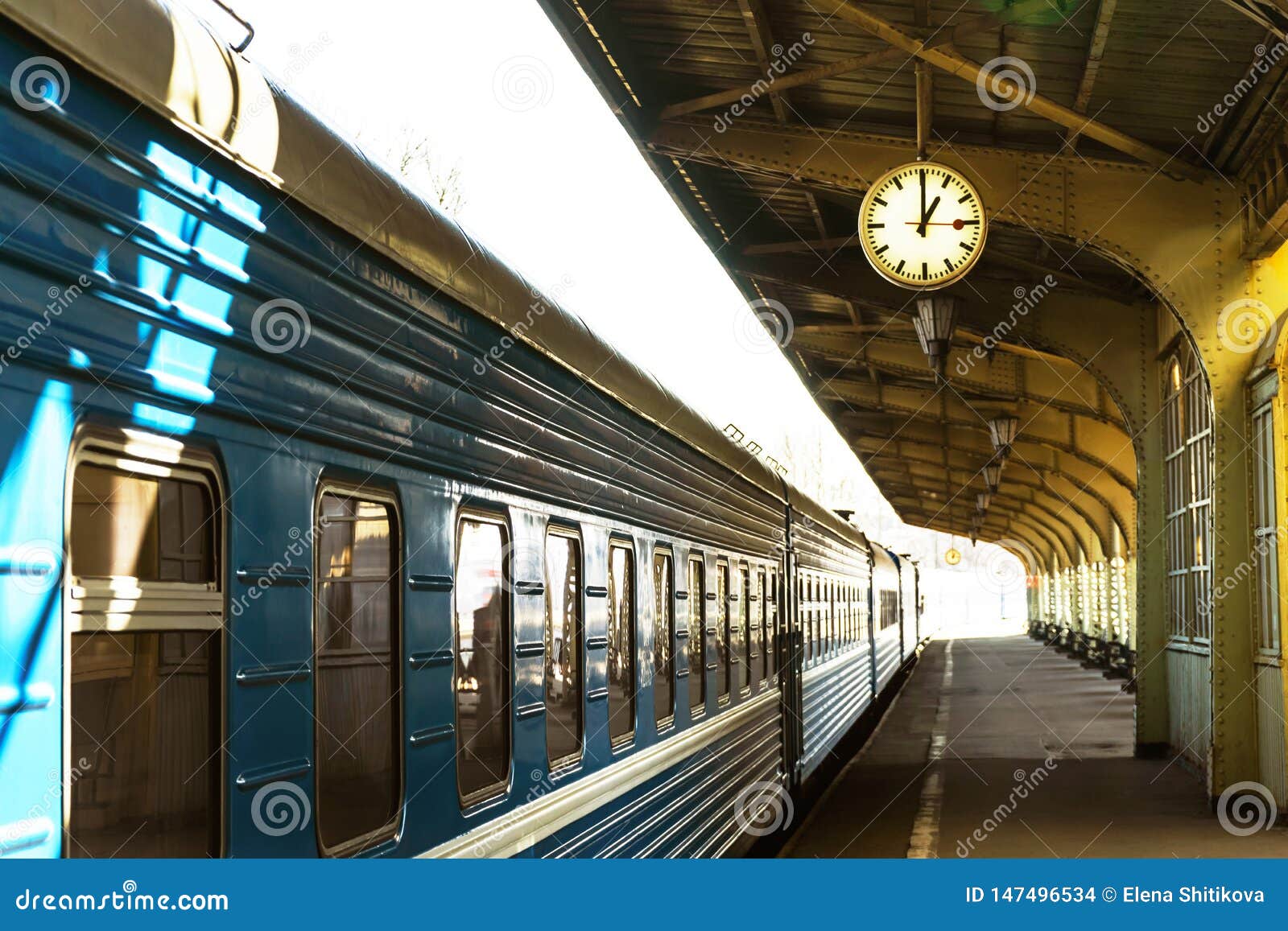 The Train Stands on the Station Platform. Station Clock. Stock Photo ...