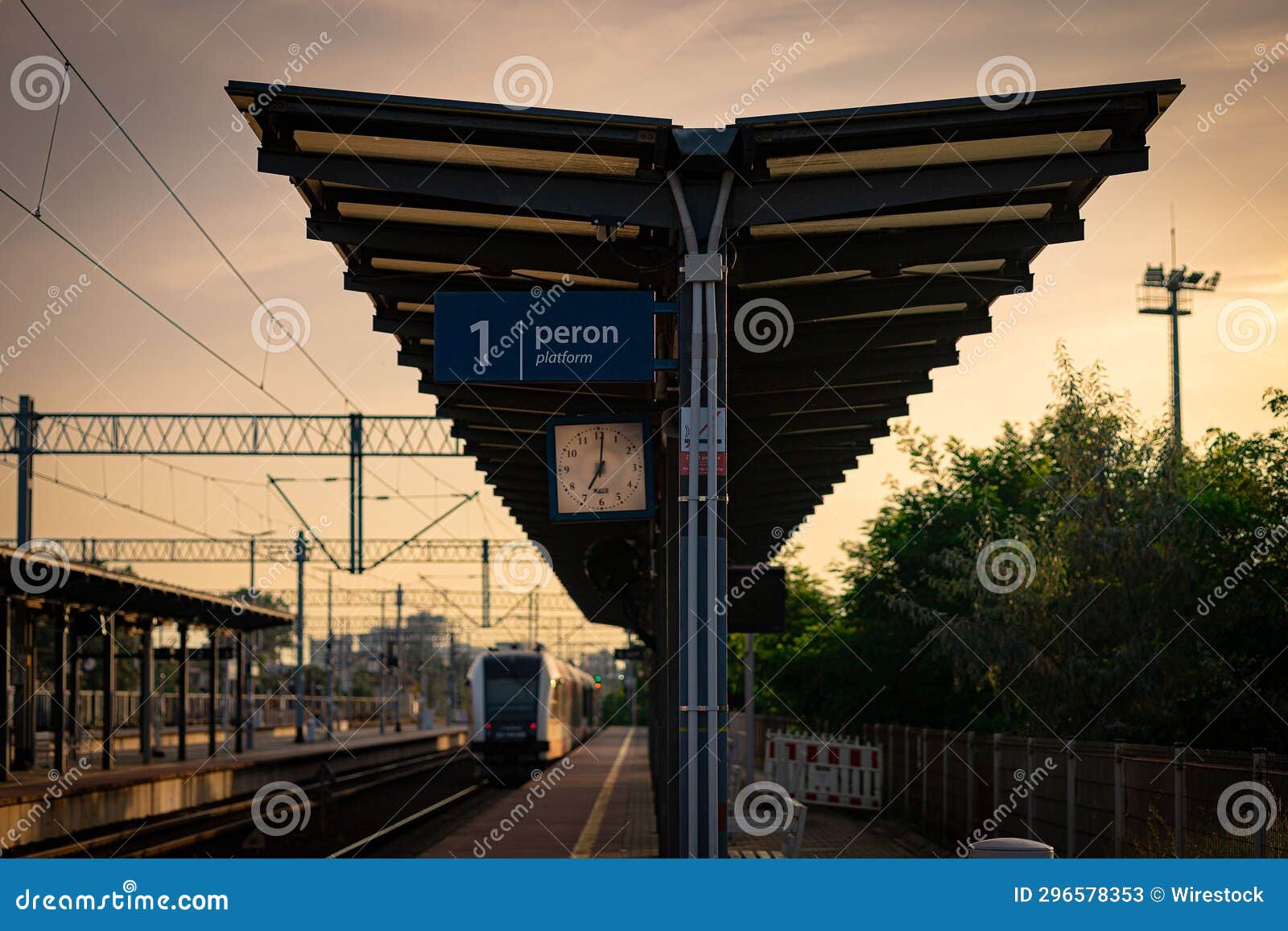 A Train at a Train Station Platform with a Bench Under it Editorial ...