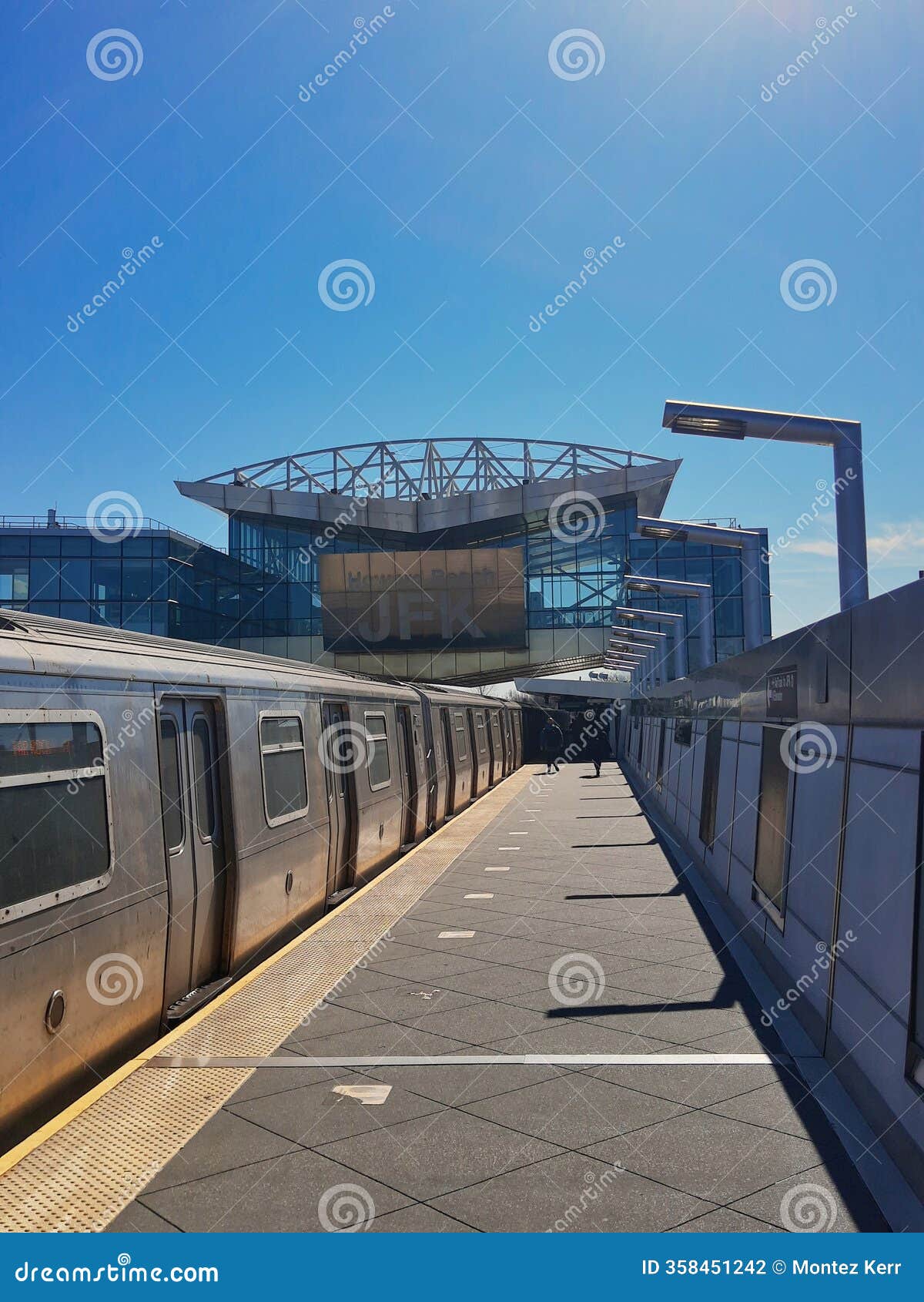 A Train is Stationed at a Modern Platform Under a Clear Blue Sky ...