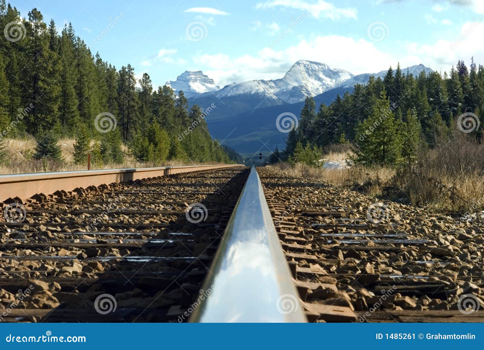 A Train On A Train Track And Electricity Power Plant With A Mountain In ...