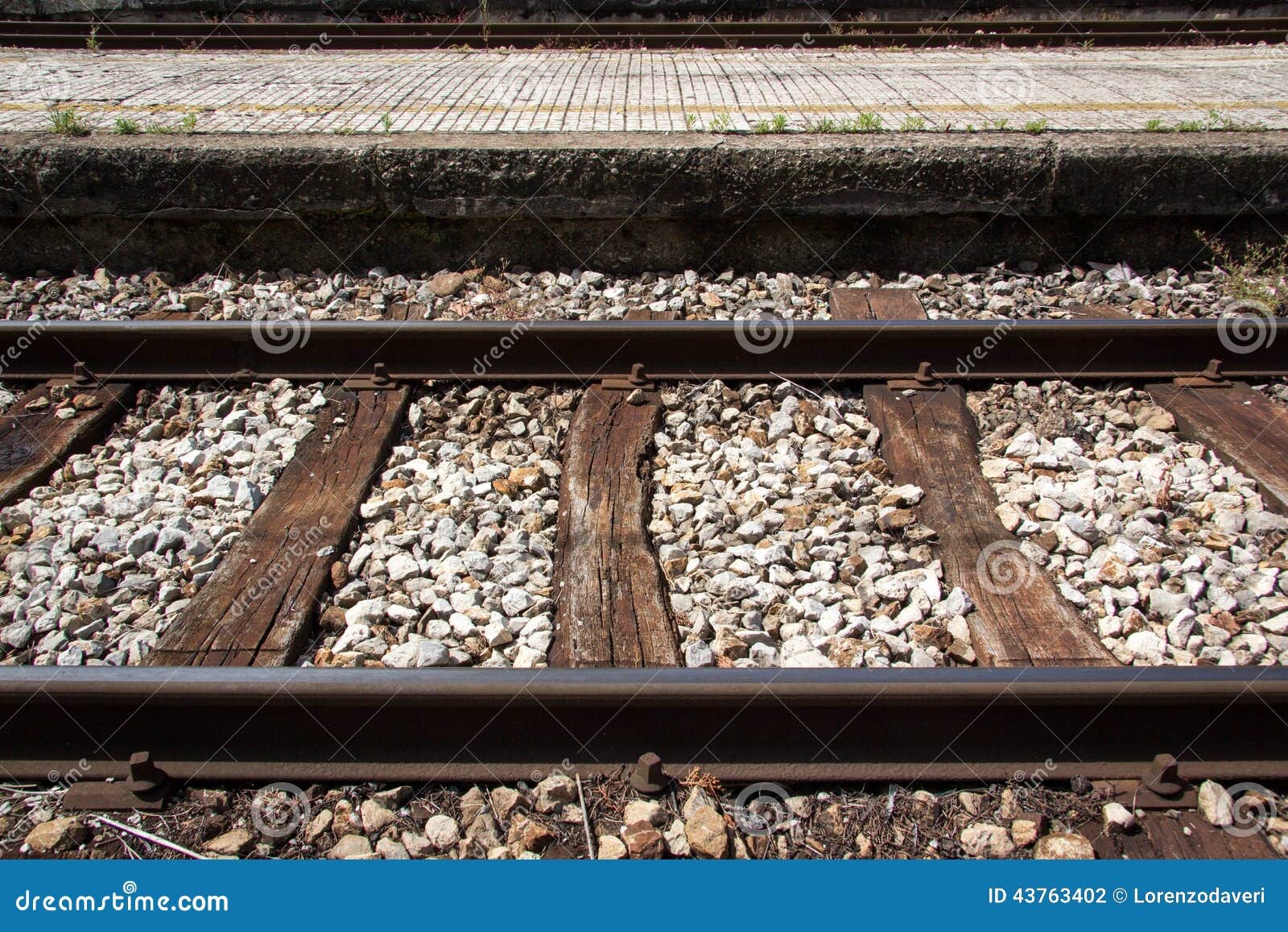 Train Track with Platform and Red Grass on Them Stock Photo - Image of ...
