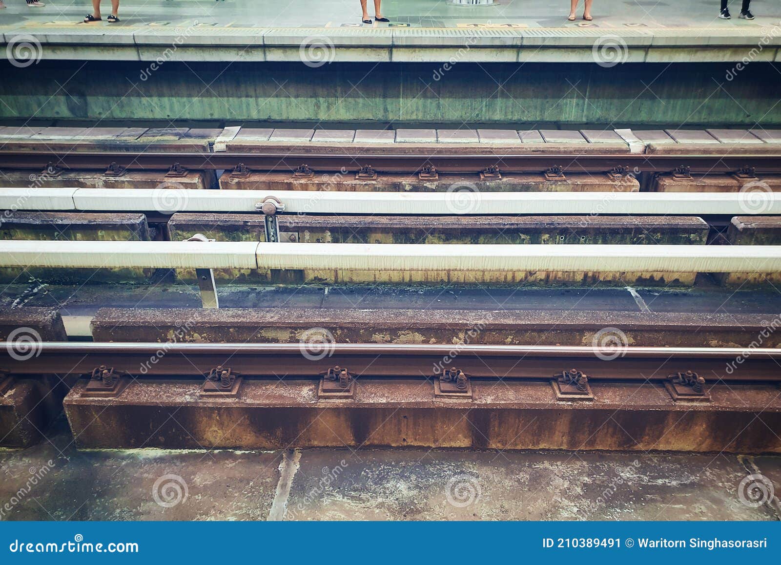 Train Track at Train Station with Office Worker`s Legs Background Stock ...