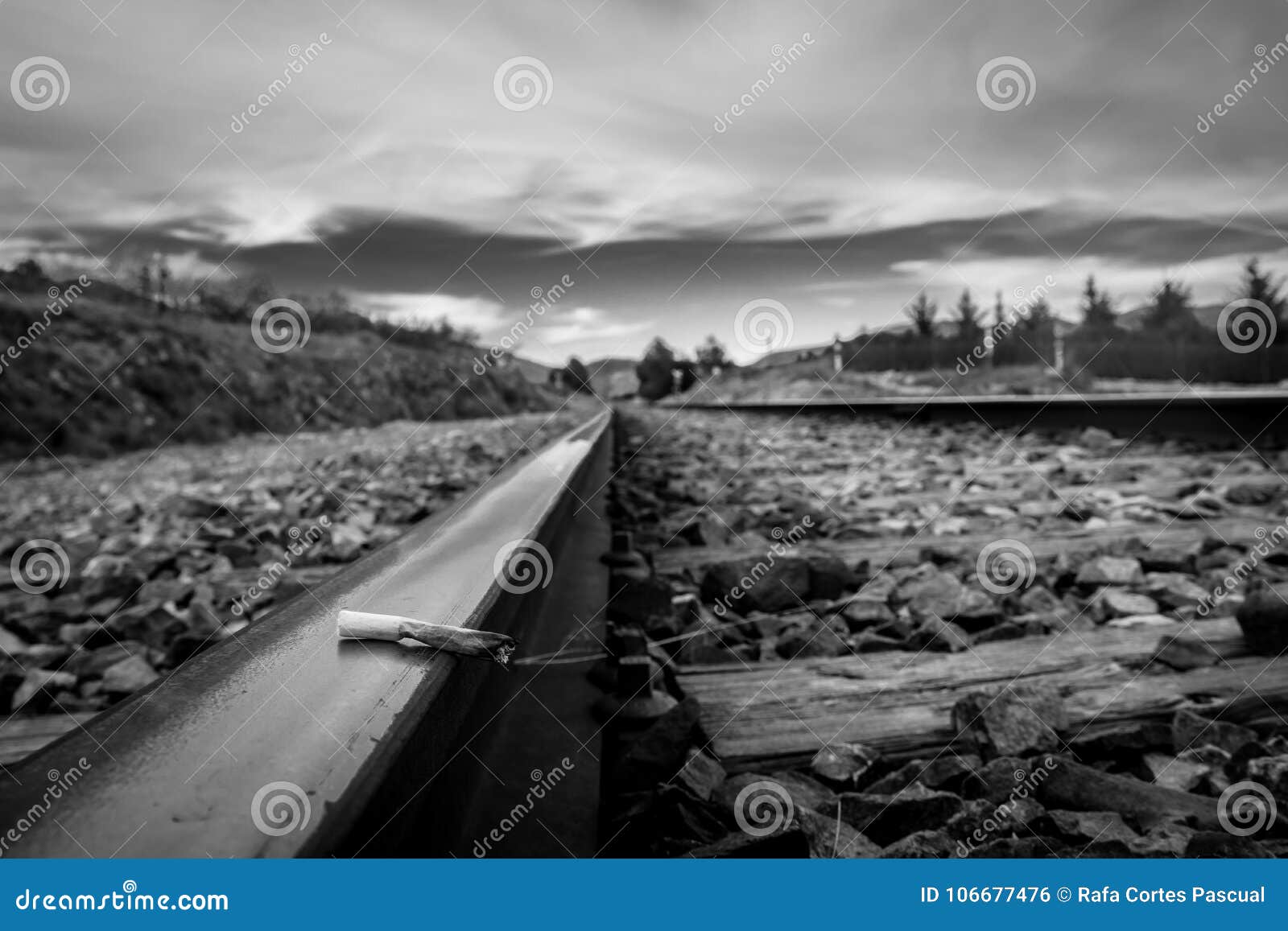 Train Tracks with a Cigarette on a Railroad. Dramatic Concept Stock ...