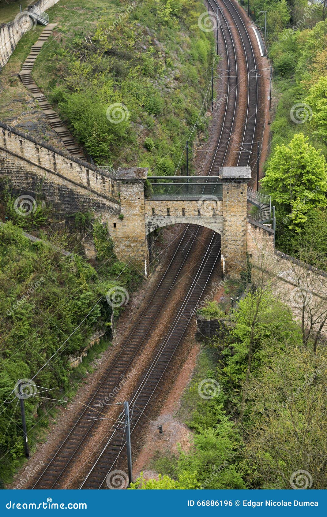 Train Tracks Passing Under Old Ruins Stock Photo - Image of train ...