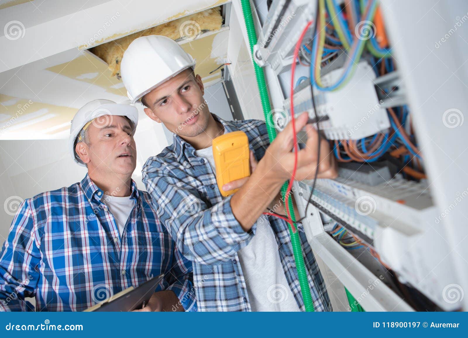 Trainee Electrician Working on Fusebox Under Supervision Stock Image ...