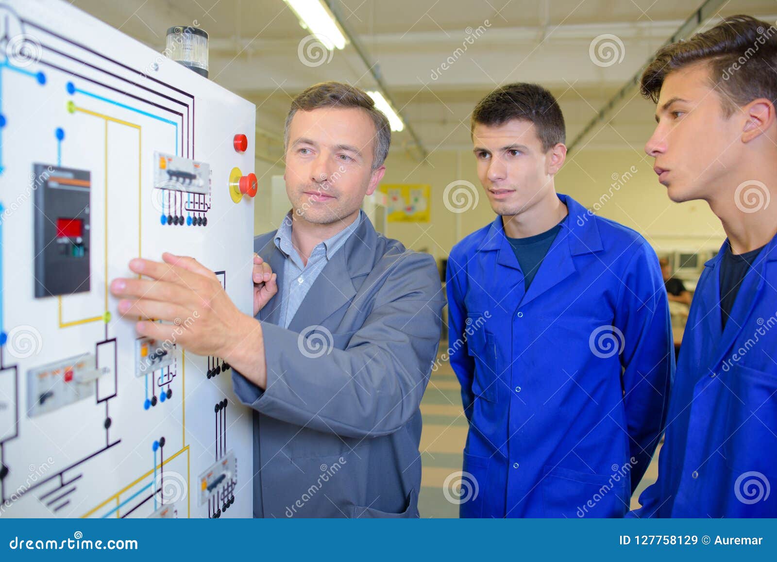 Trainee Electricians Looking at Wiring Plan Stock Image - Image of ...