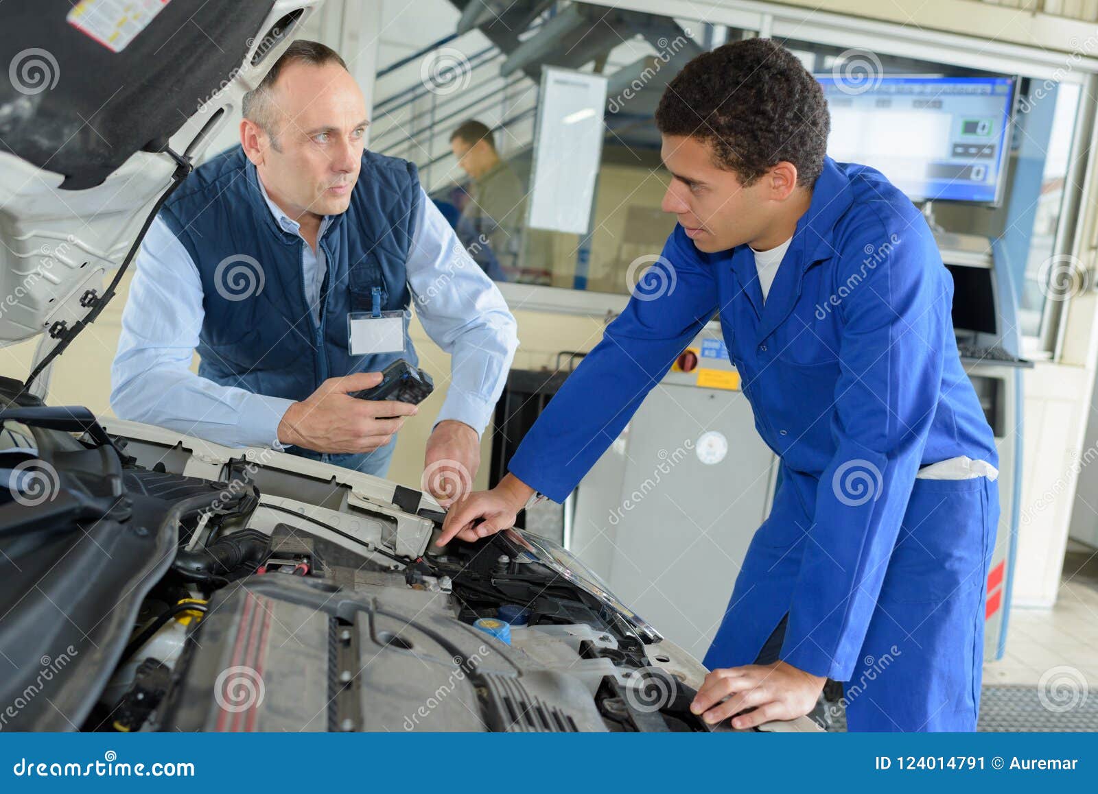 Trainee mechanic at work stock image. Image of boss - 124014791