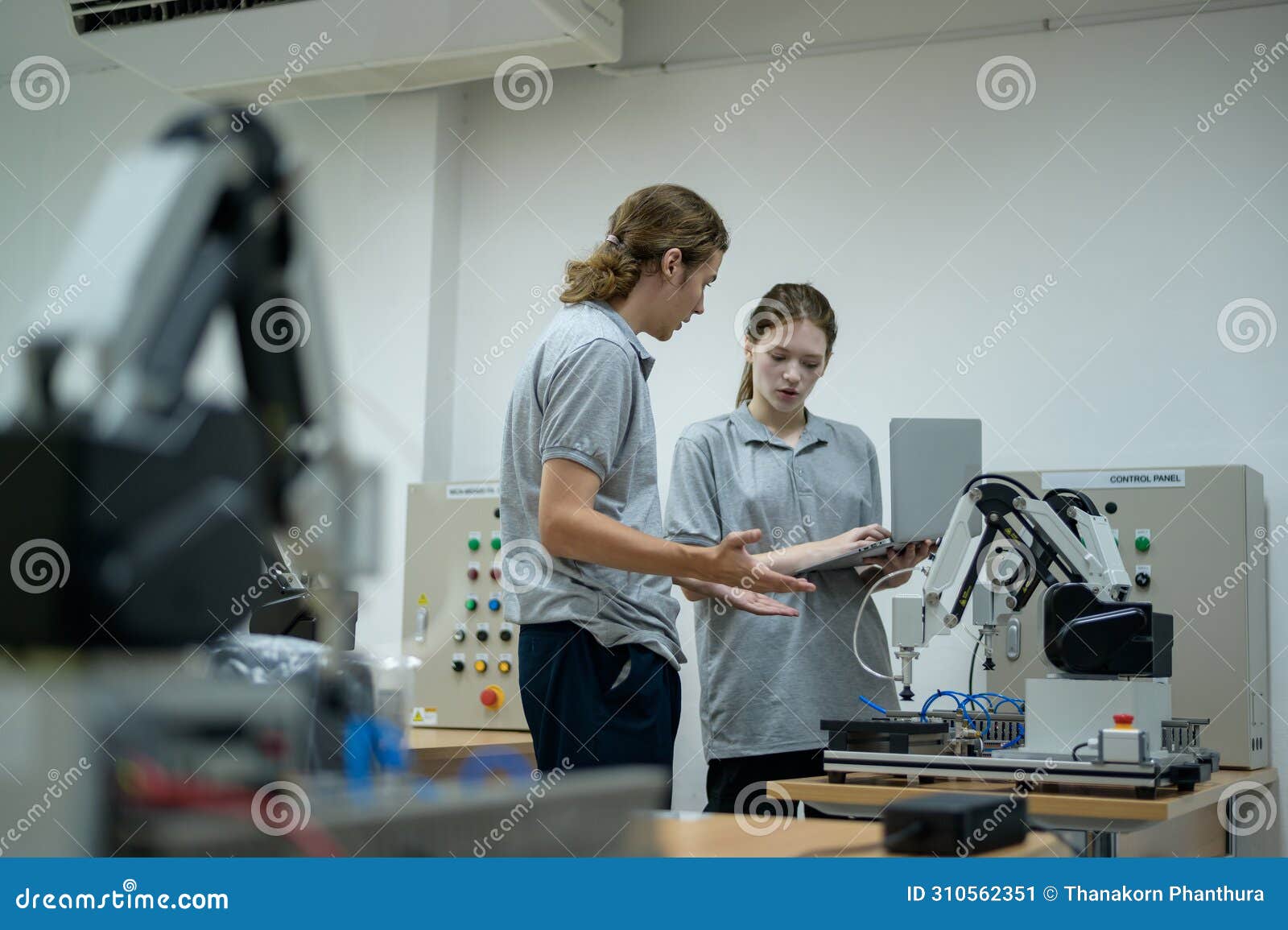 Trainee Robotics Engineer Learning with Programming and Manipulating ...
