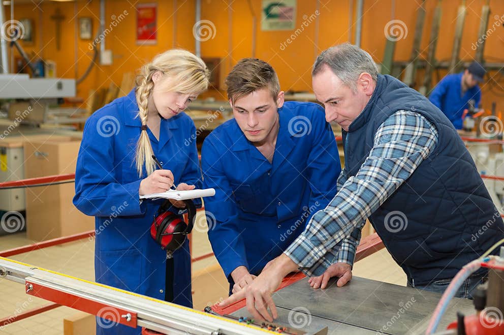 Trainee Taking Notes while Supervisor Explains Machinery Stock Photo ...