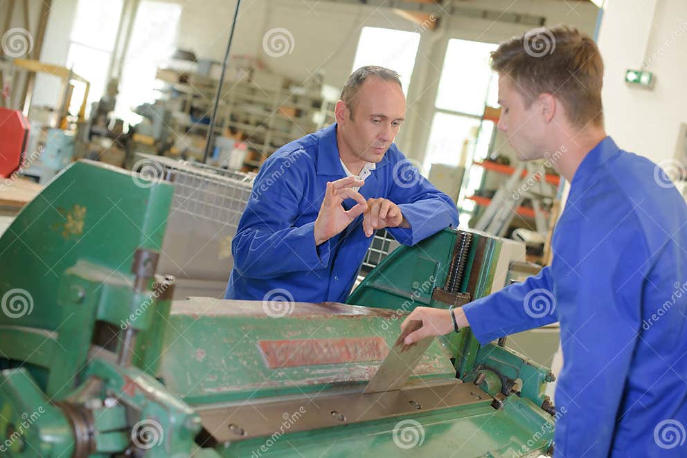 Trainee Using Machine Superviser Approving Work Stock Image - Image of ...