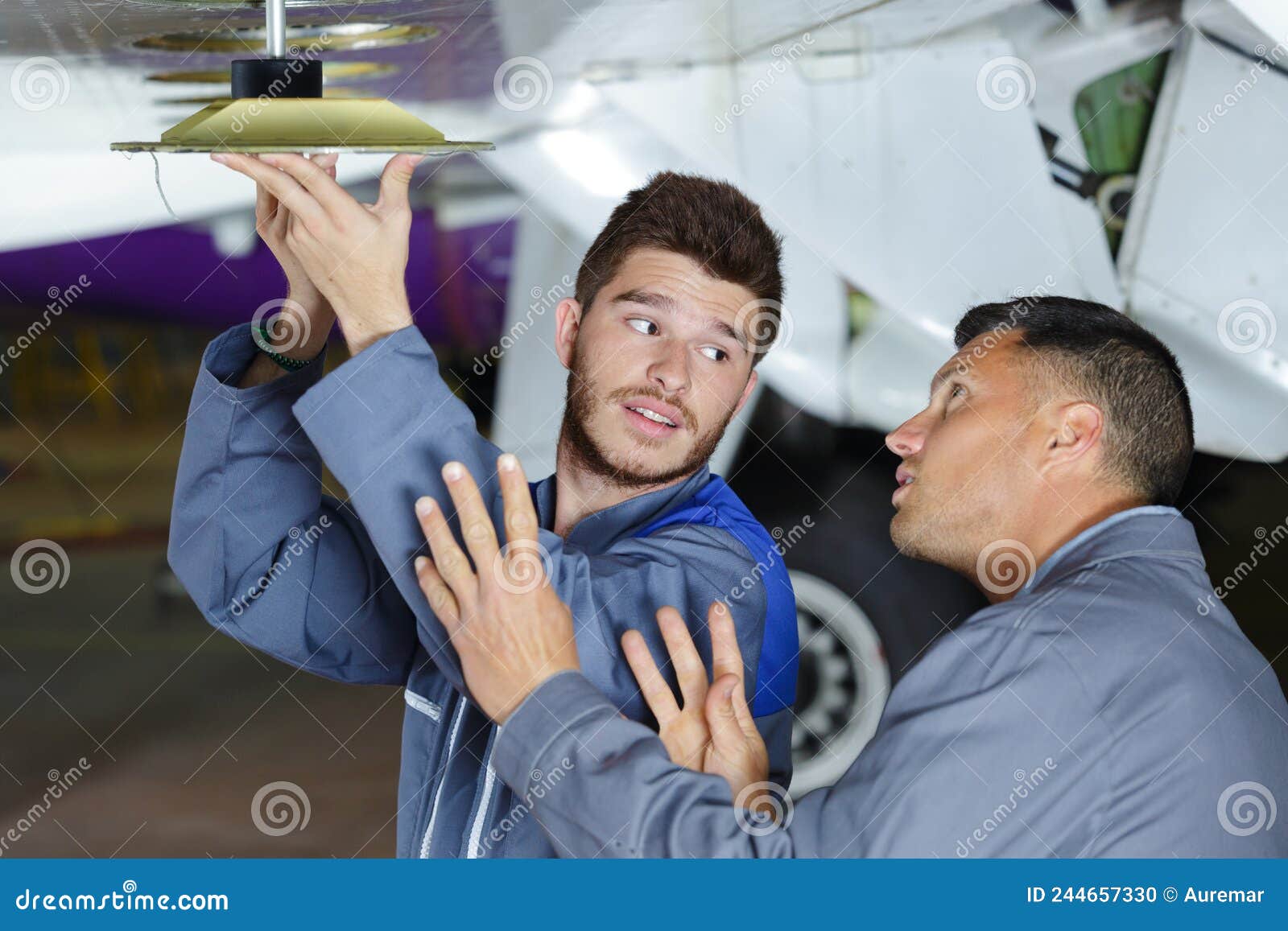 Trainee Working Underneath Aircraft Under Supervision Stock Photo ...