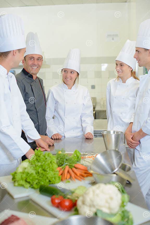 Trainees in Kitchen with Chef Stock Photo - Image of people, food ...