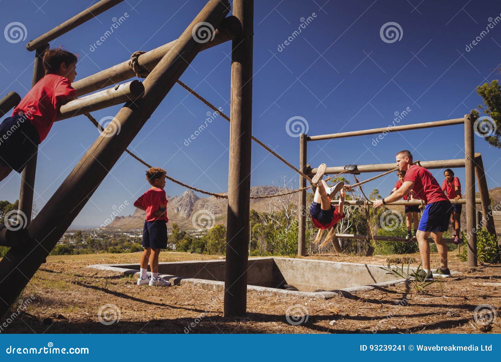 Trainer Assisting a Girl in Obstacle Course Training Stock Image ...
