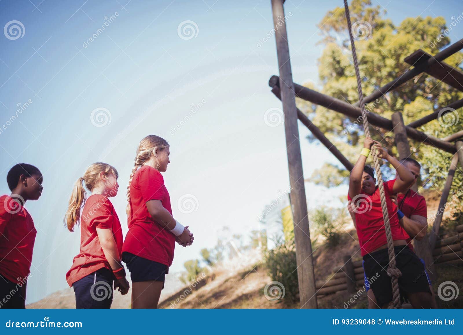 Trainer Assisting a Kid To Climb a Rope in the Boot Camp Stock Photo ...