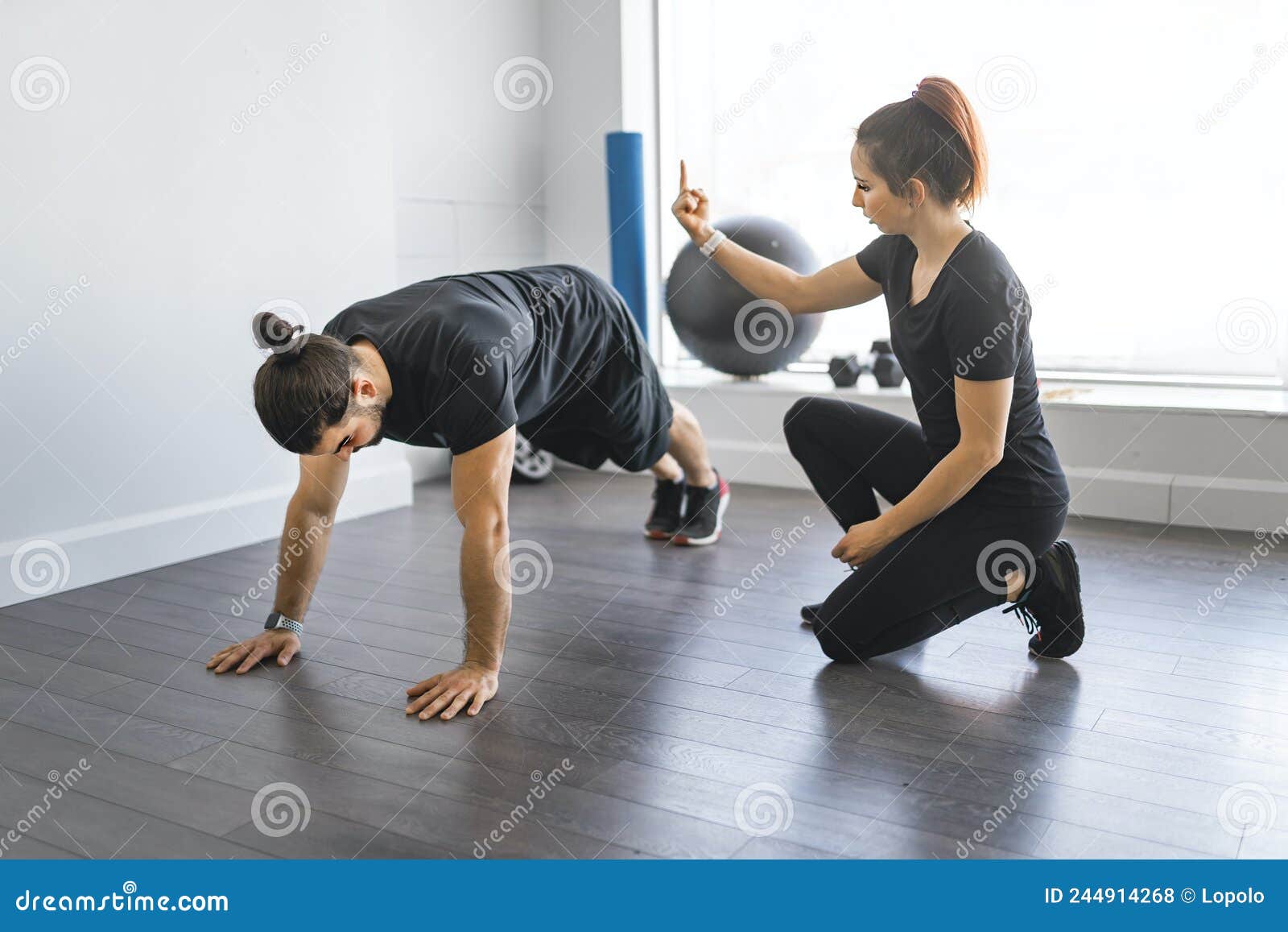Trainer and Client Discussing Her Progress at the Gym Stock Photo ...