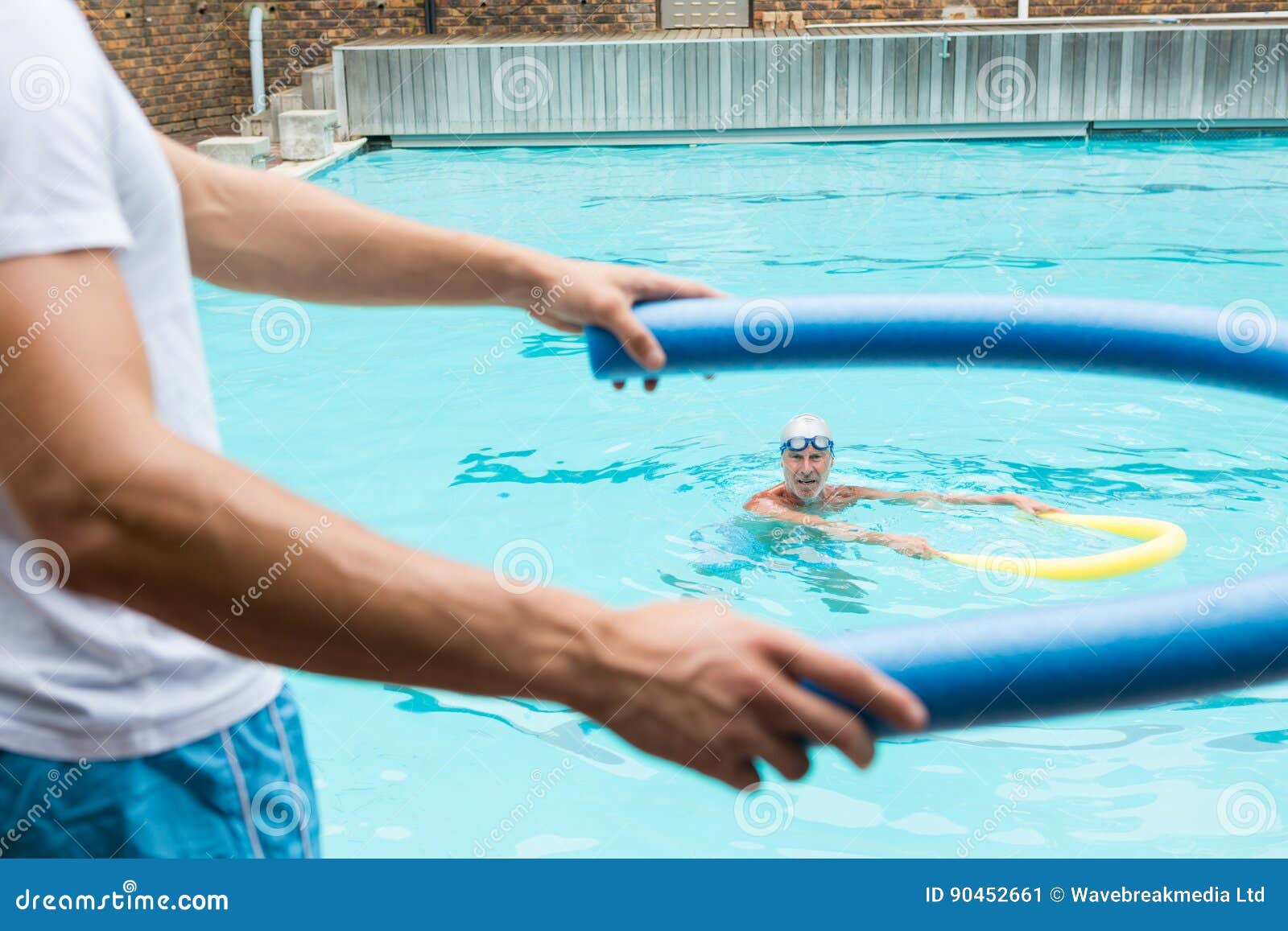 Trainer Demonstrating Use of Pool Noodle Stock Image - Image of senior ...