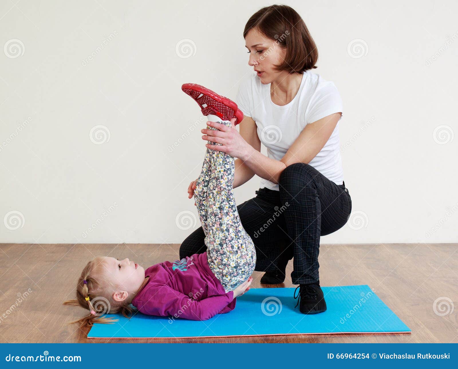 Trainer is Doing Back Exercise with a Little Girl Stock Photo - Image ...