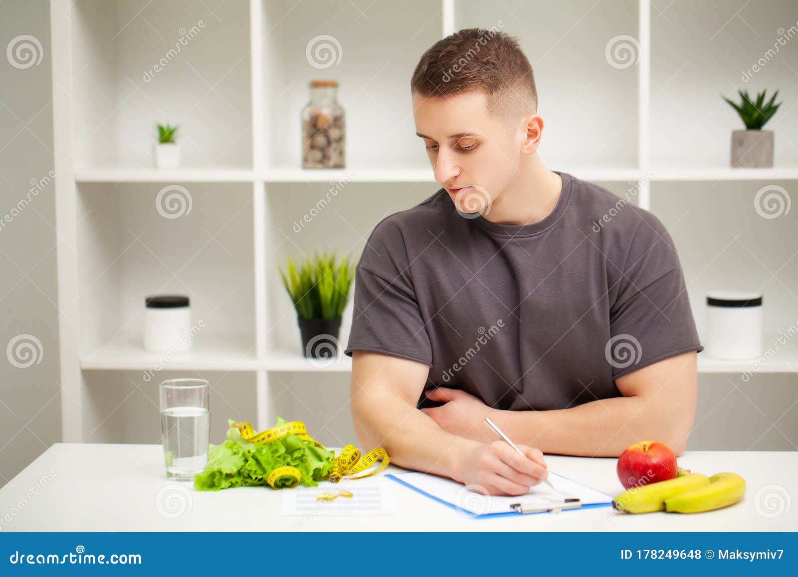 Trainer Draws Up a Training Program and a Healthy Diet Plan Stock Photo ...
