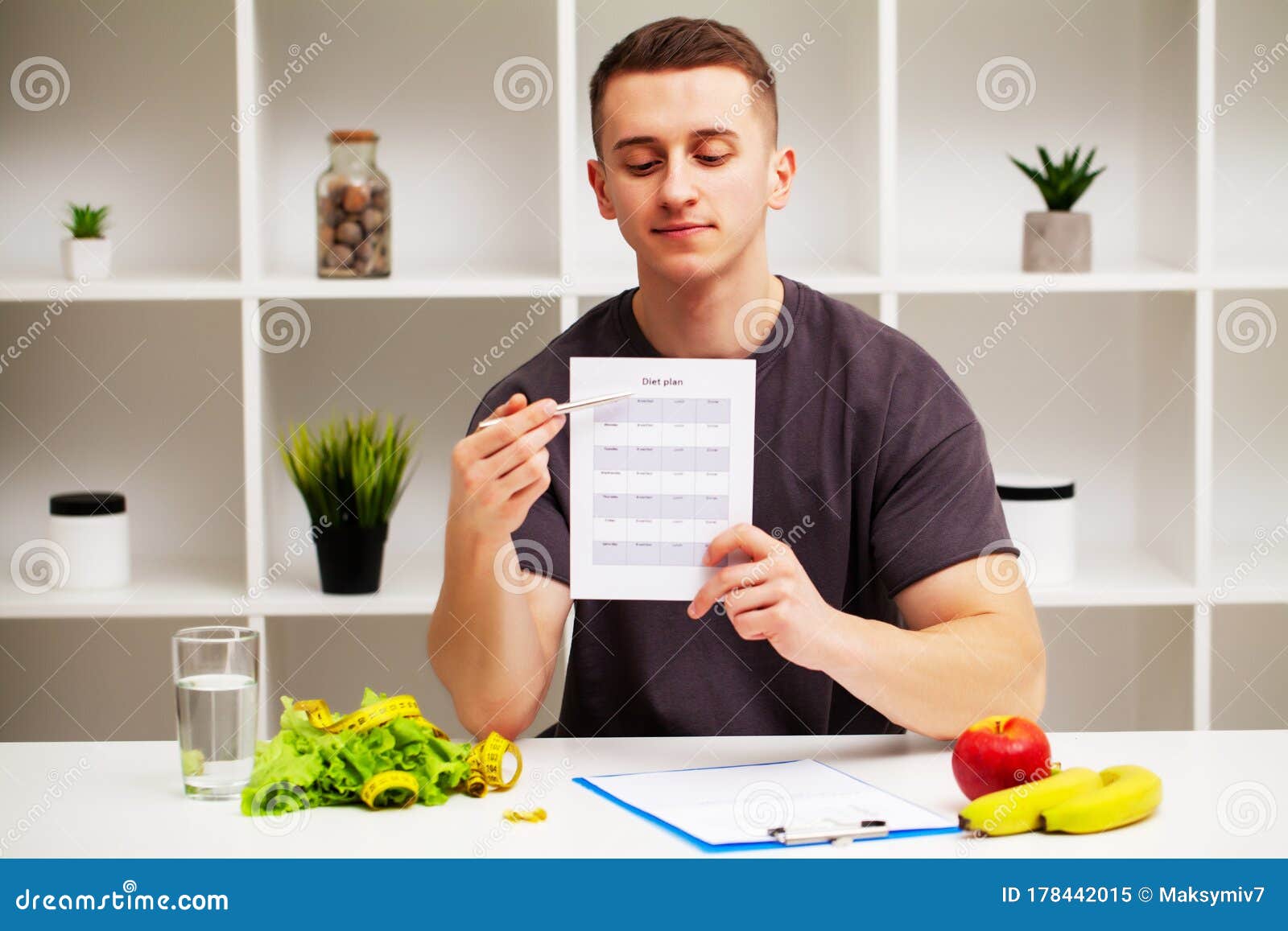 Trainer Draws Up a Training Program and a Healthy Diet Plan. Stock ...