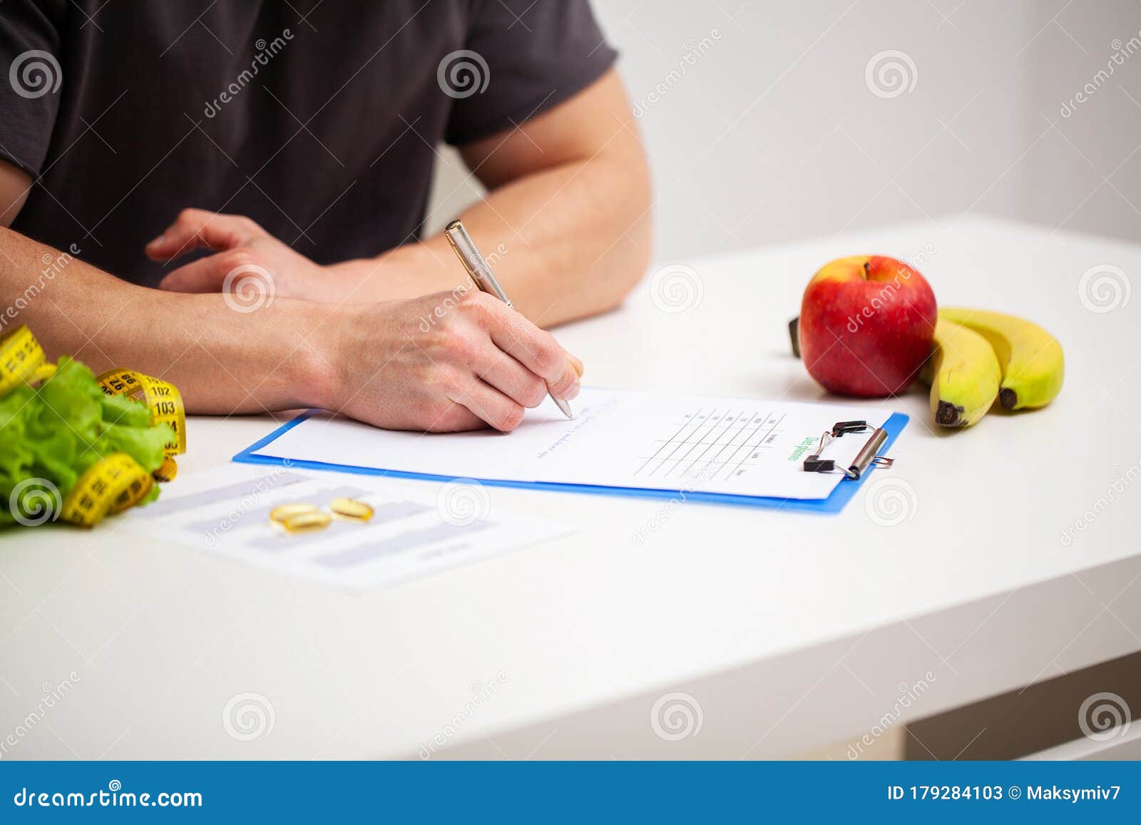 Trainer Draws Up a Training Program and a Healthy Diet Plan. Stock ...