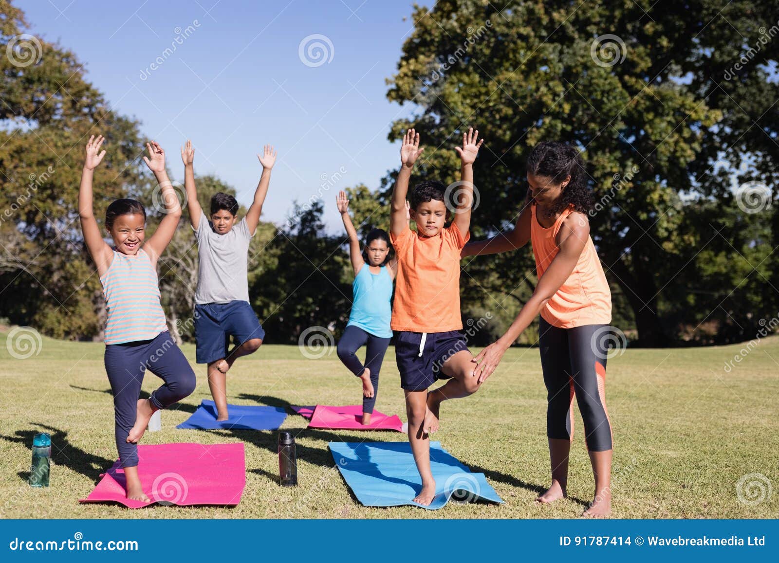 Trainer Examining Kids Practicing Yoga Stock Photo - Image of focus ...