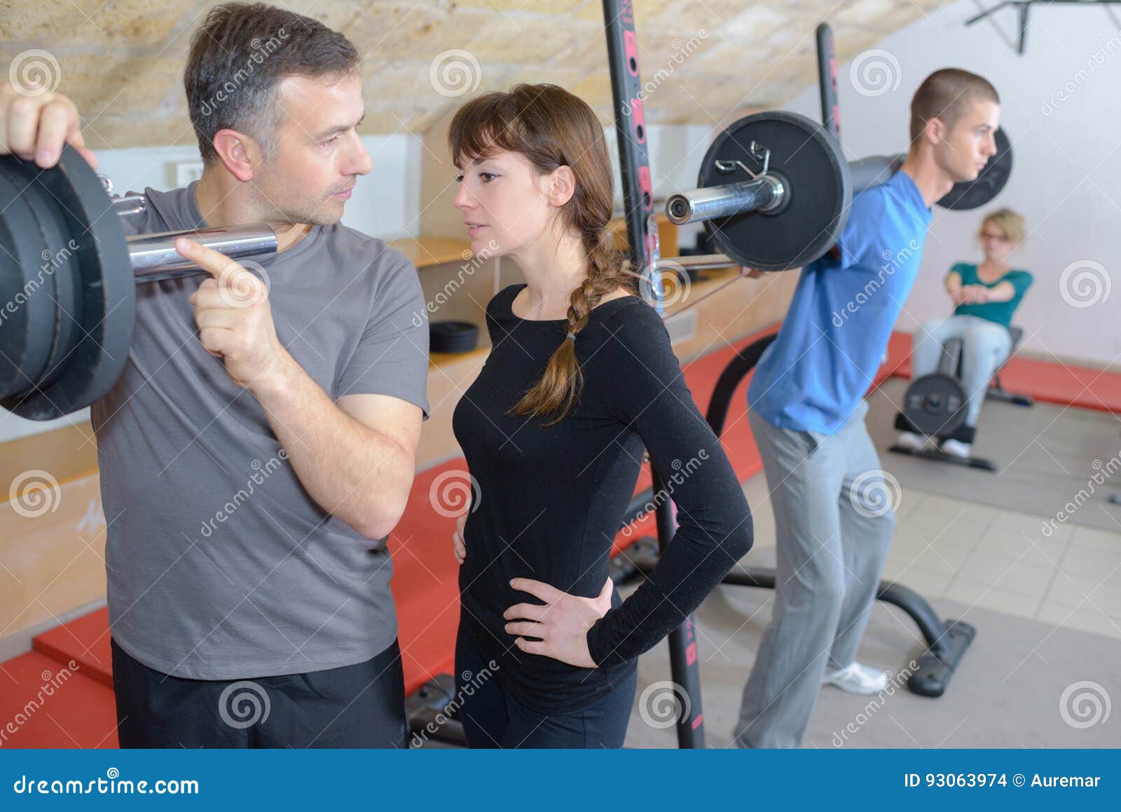 Trainer Explaining How To Use Training Machine in Gym Stock Photo ...