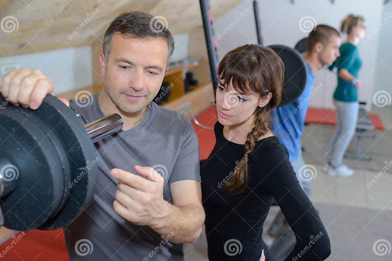 Trainer Explaining How To Use Training Machine in Gym Stock Photo ...