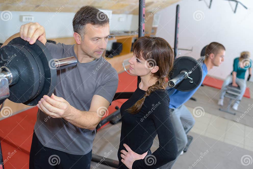 Trainer Explaining How To Use Training Machine in Gym Stock Photo ...