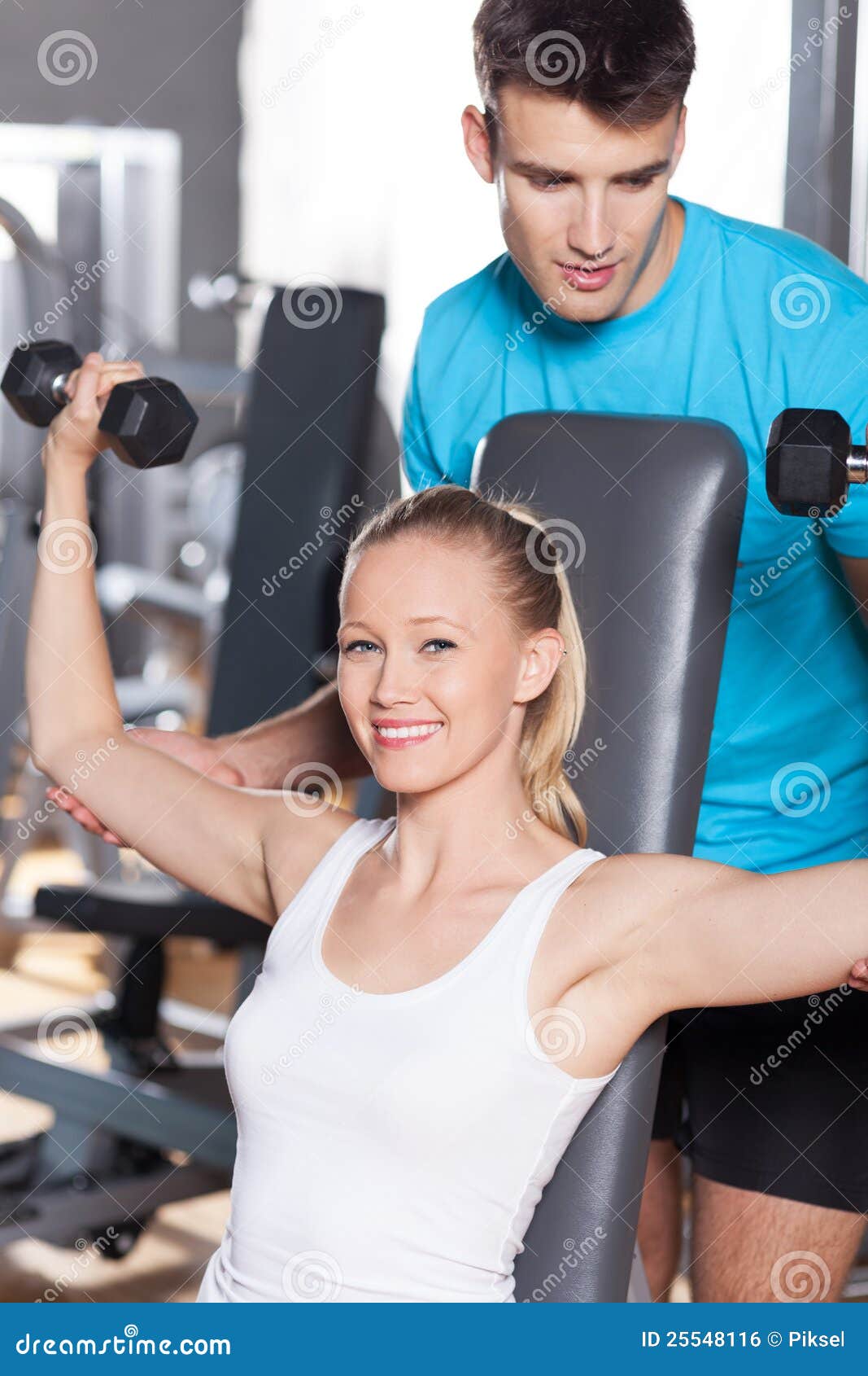 Trainer Helping a Woman Work Out with Dumbbells Stock Photo - Image of ...