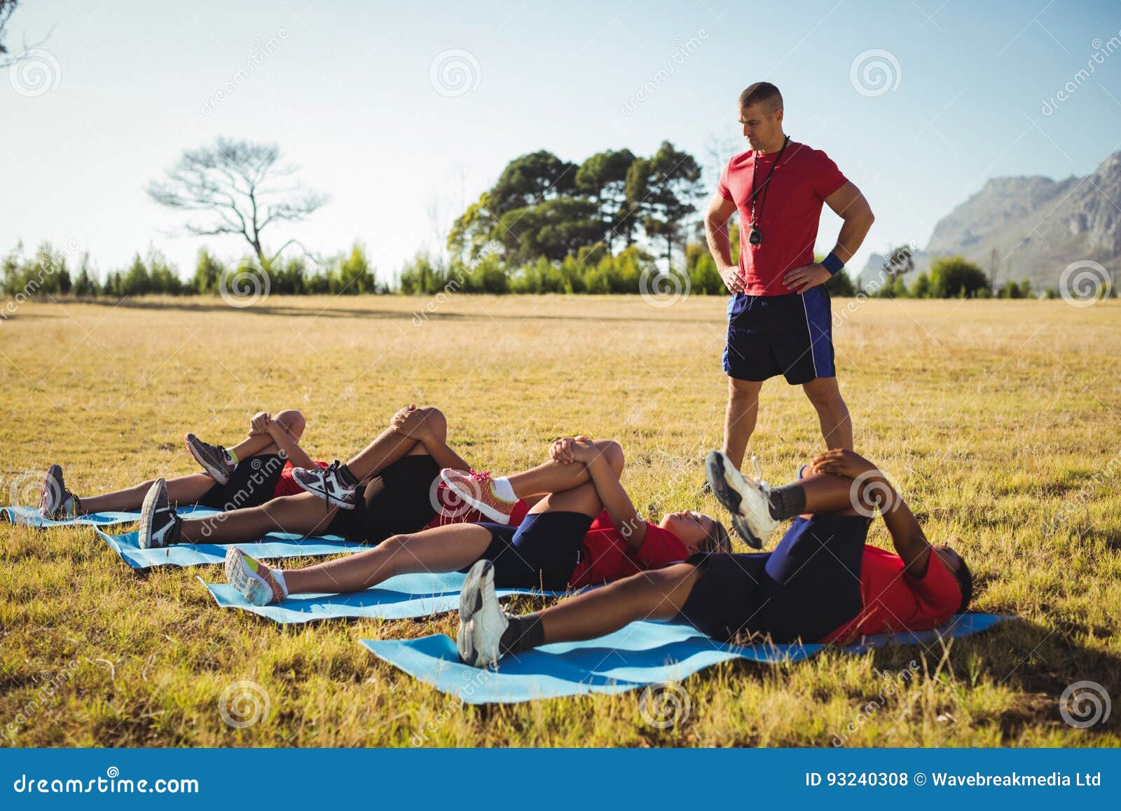 Trainer Instructing Kids while Exercising in the Boot Camp Stock Photo ...