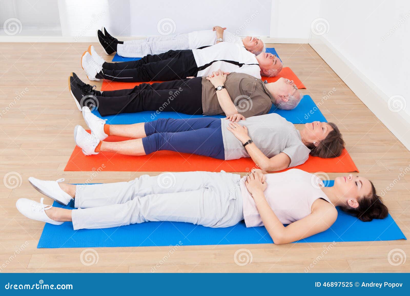 Trainer and Senior People Lying on Exercise Mats Stock Image - Image of ...