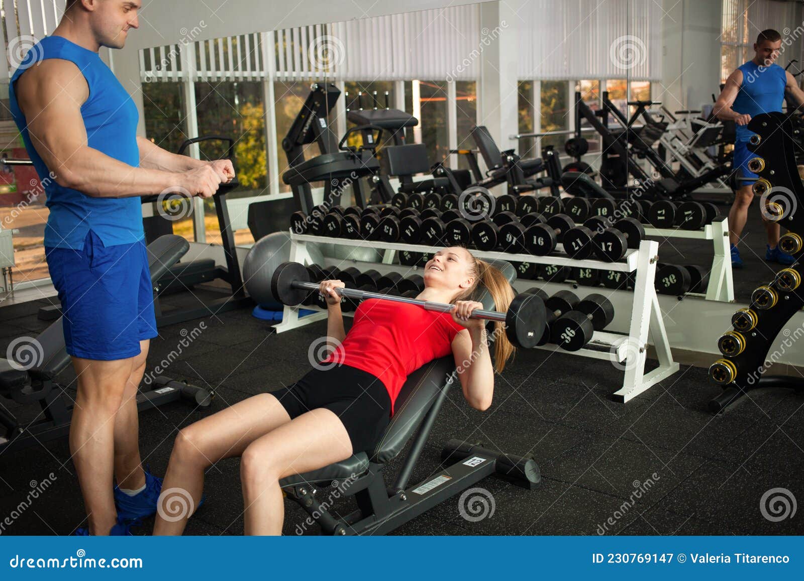 Trainer Shows the Correct Performance of the Exercise in the Gym ...