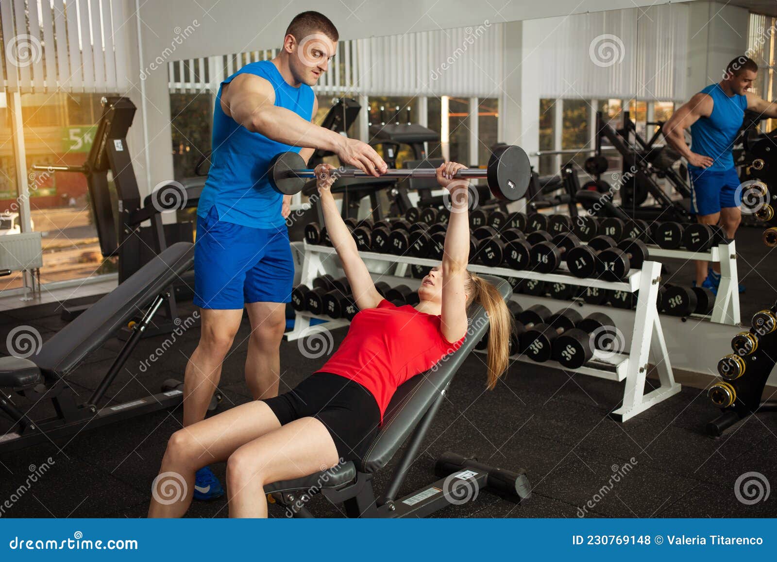 Trainer Shows the Correct Performance of the Exercise in the Gym ...