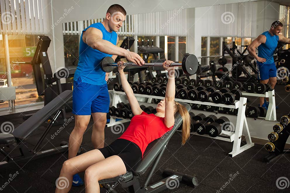 Trainer Shows the Correct Performance of the Exercise in the Gym ...