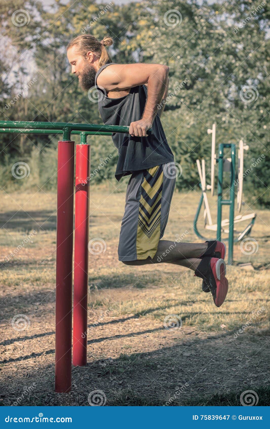 Training Outdoors. Man Doing Biceps and Triceps Dips Training. Stock ...