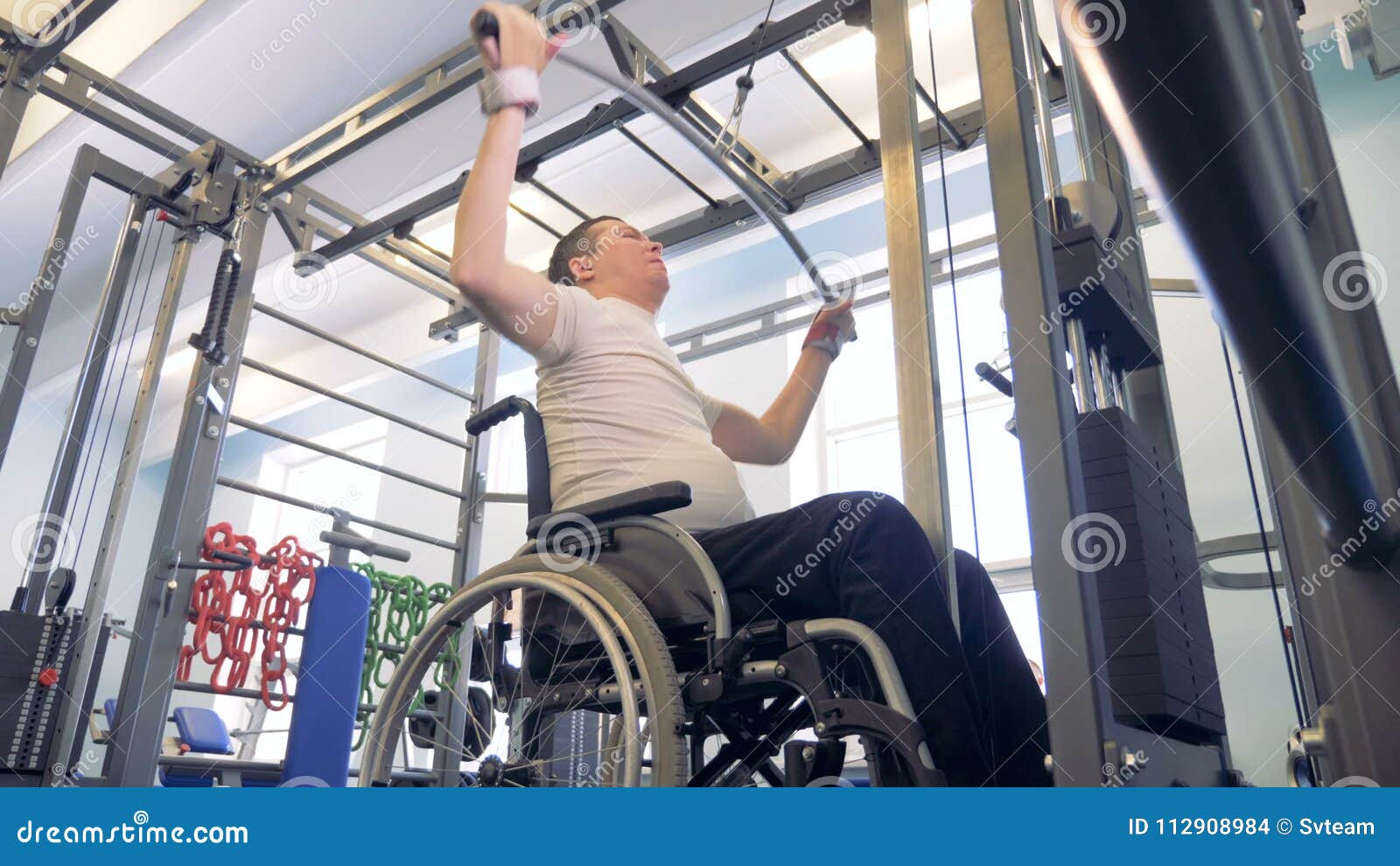 Training Process of a Disabled Man in a Wheelchair with a Weight ...