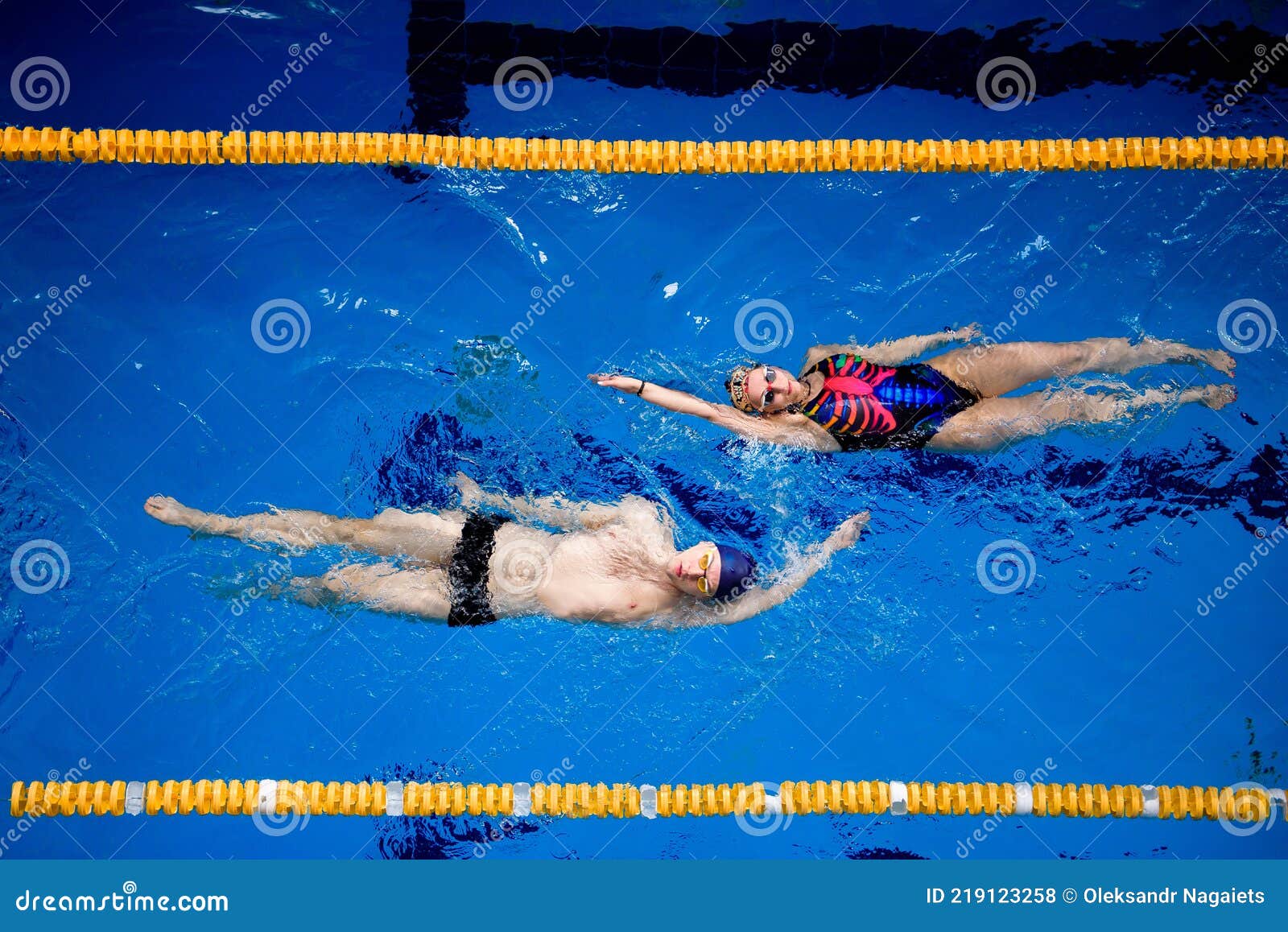 Training of Professional Swimmers. Athletes Swim on Their Backs in the ...