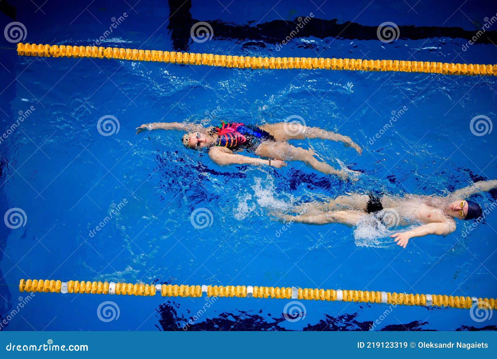 Training of Professional Swimmers. Athletes Swim on Their Backs in the ...