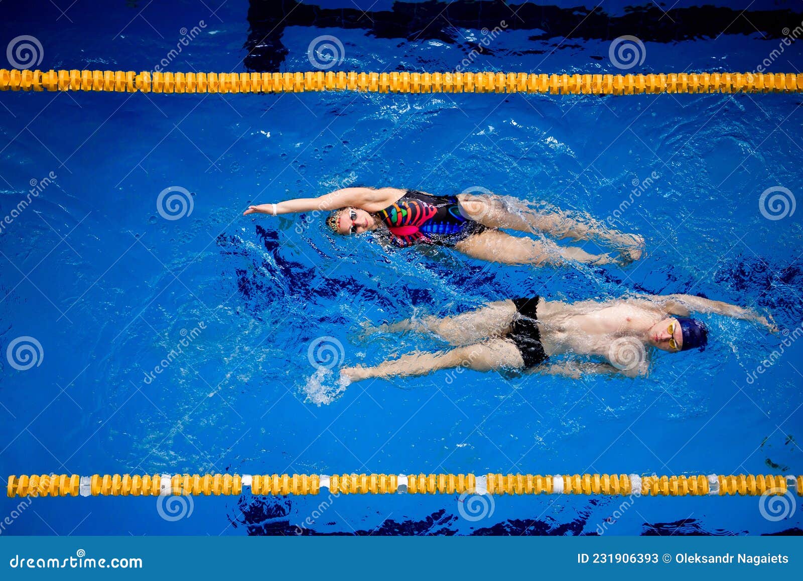 Training of Professional Swimmers. Athletes Swim on Their Backs in the ...